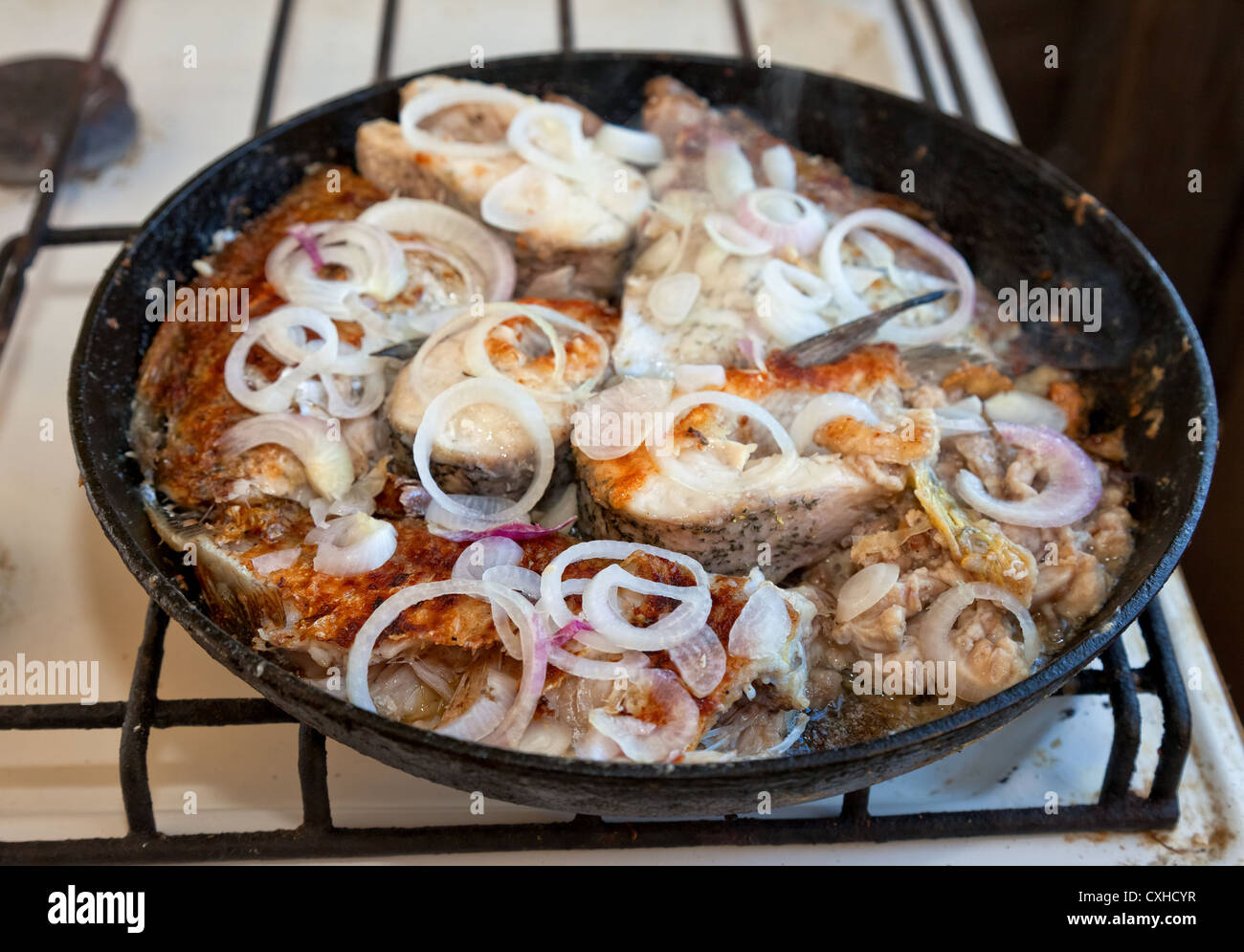 Fried fish in a frying pan Stock Photo - Alamy