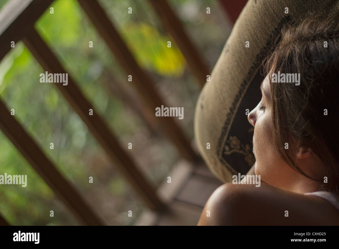 Indonesia, Young woman relaxing in veranda Stock Photo - Alamy