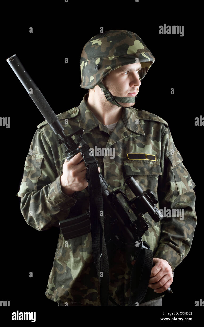 Soldier grasping a gun Stock Photo - Alamy