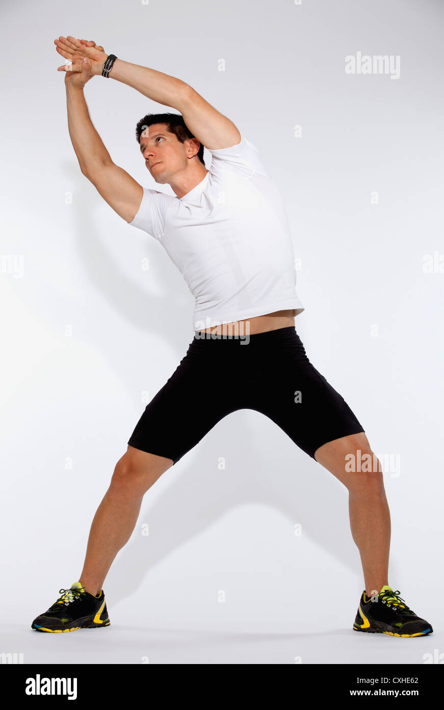 Personal trainer stretching hands against white background, close up ...