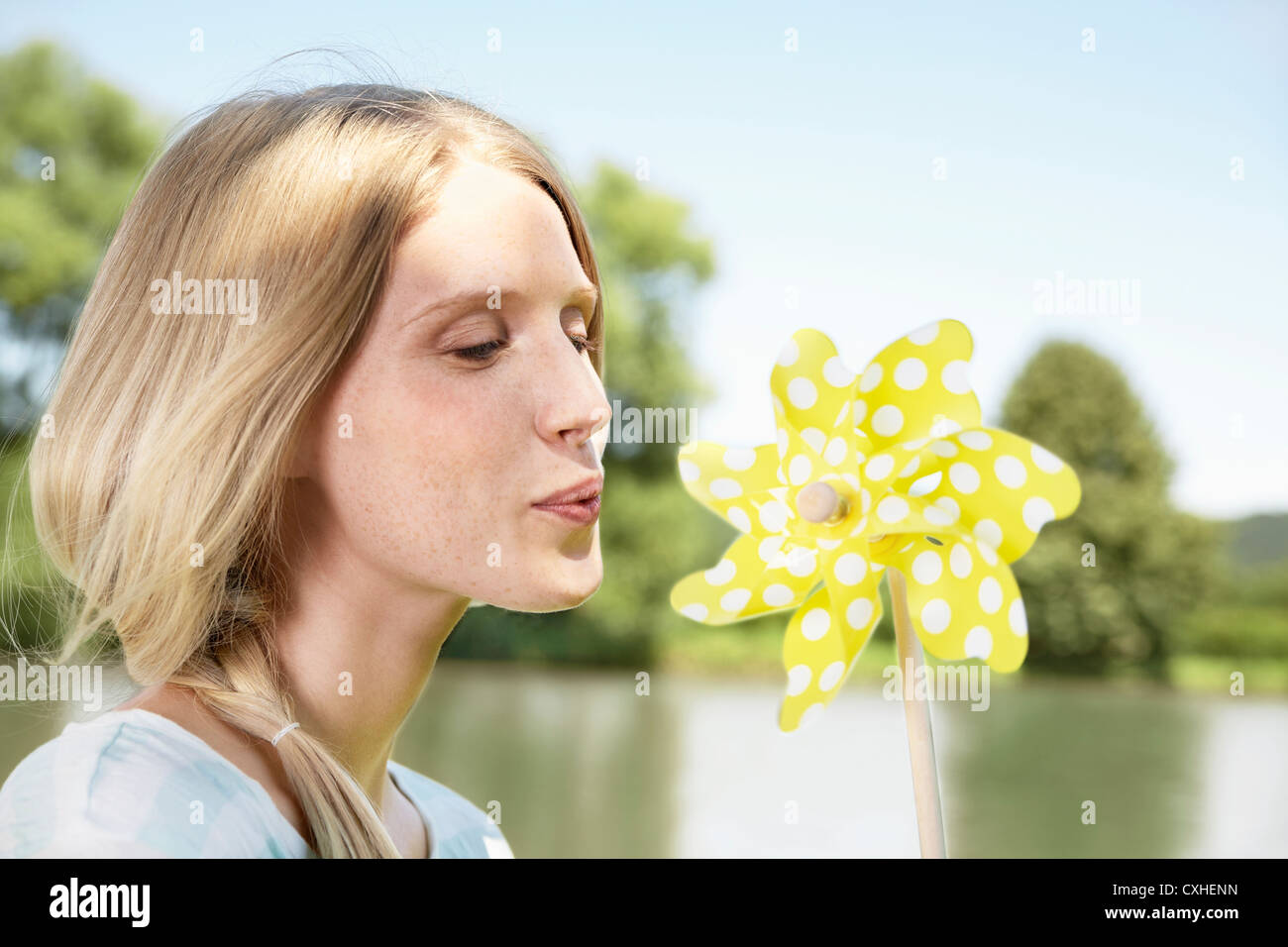 Person blowing paper windmill hi-res stock photography and images - Alamy
