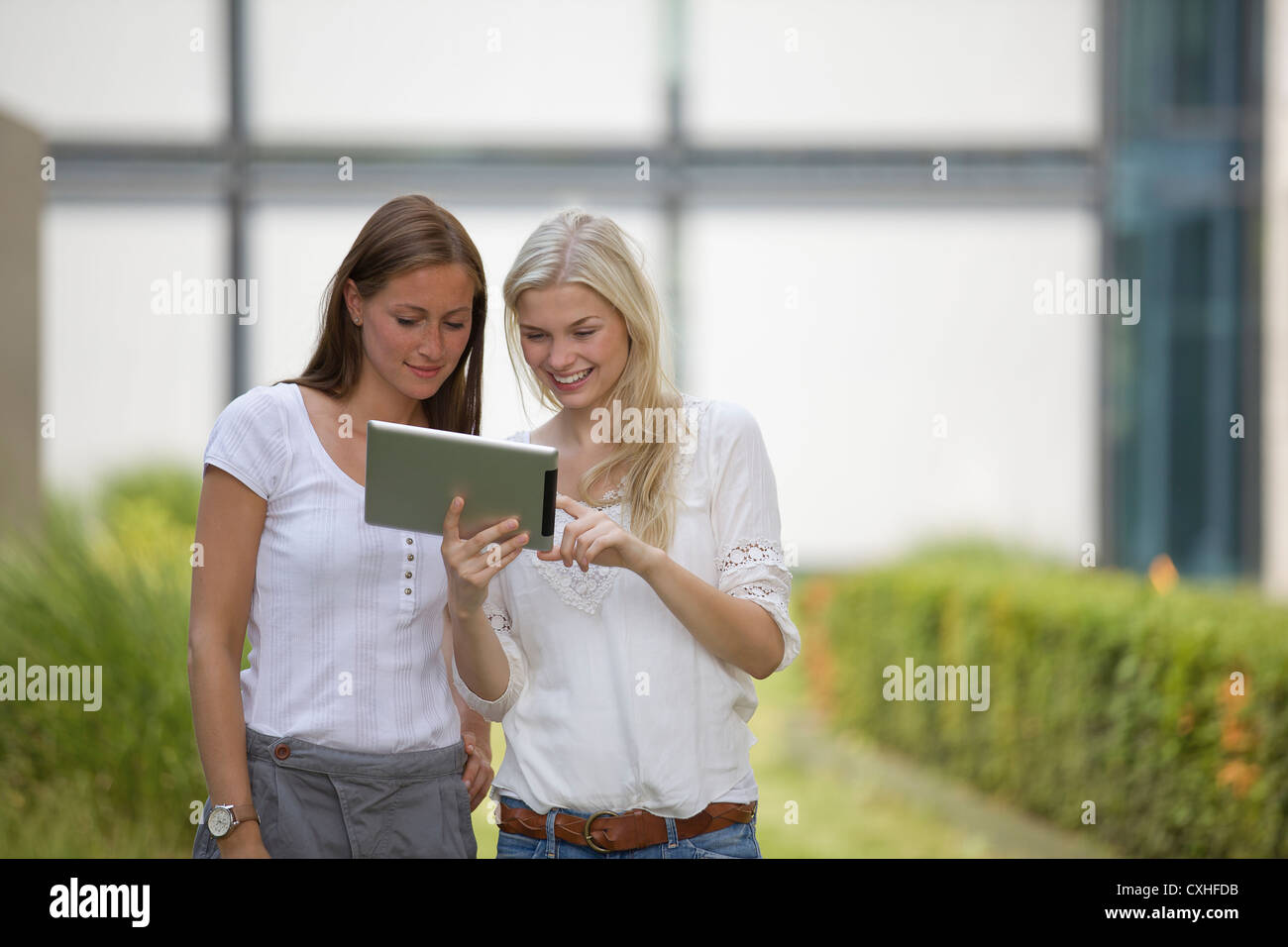 Germany, North Rhine Westphalia, Cologne, Young students using digital ...