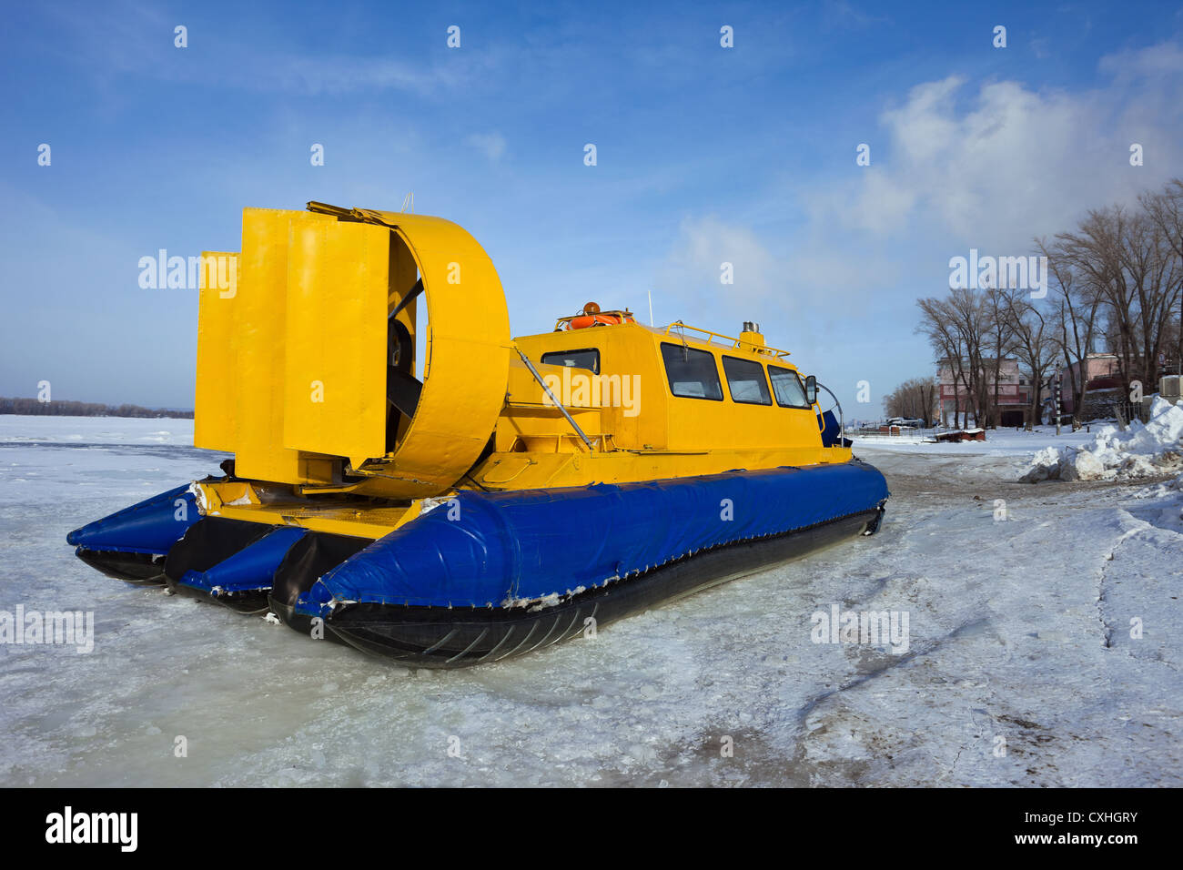 Hovercraft crossing frozen river against blue sky Stock Photo - Alamy