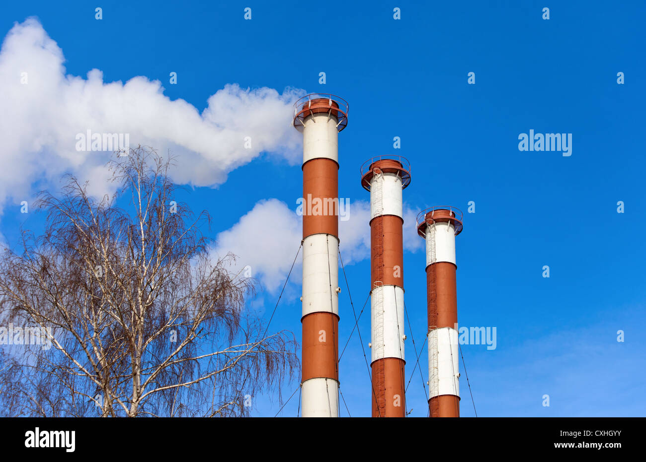 Lots of smoking chimneys other blue sky Stock Photo - Alamy