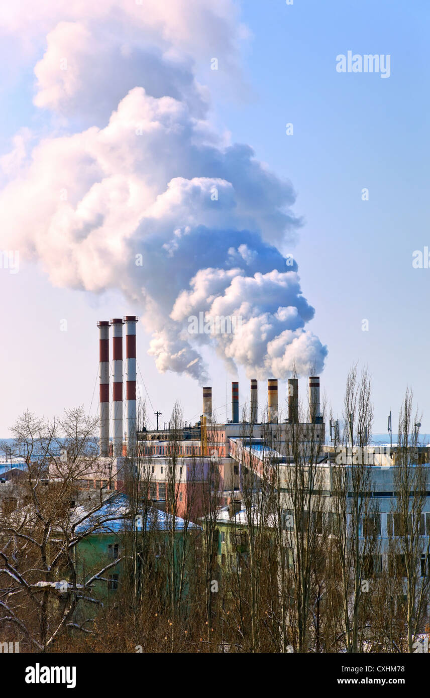 Large factory with smoking chimneys against the blue sky Stock Photo ...