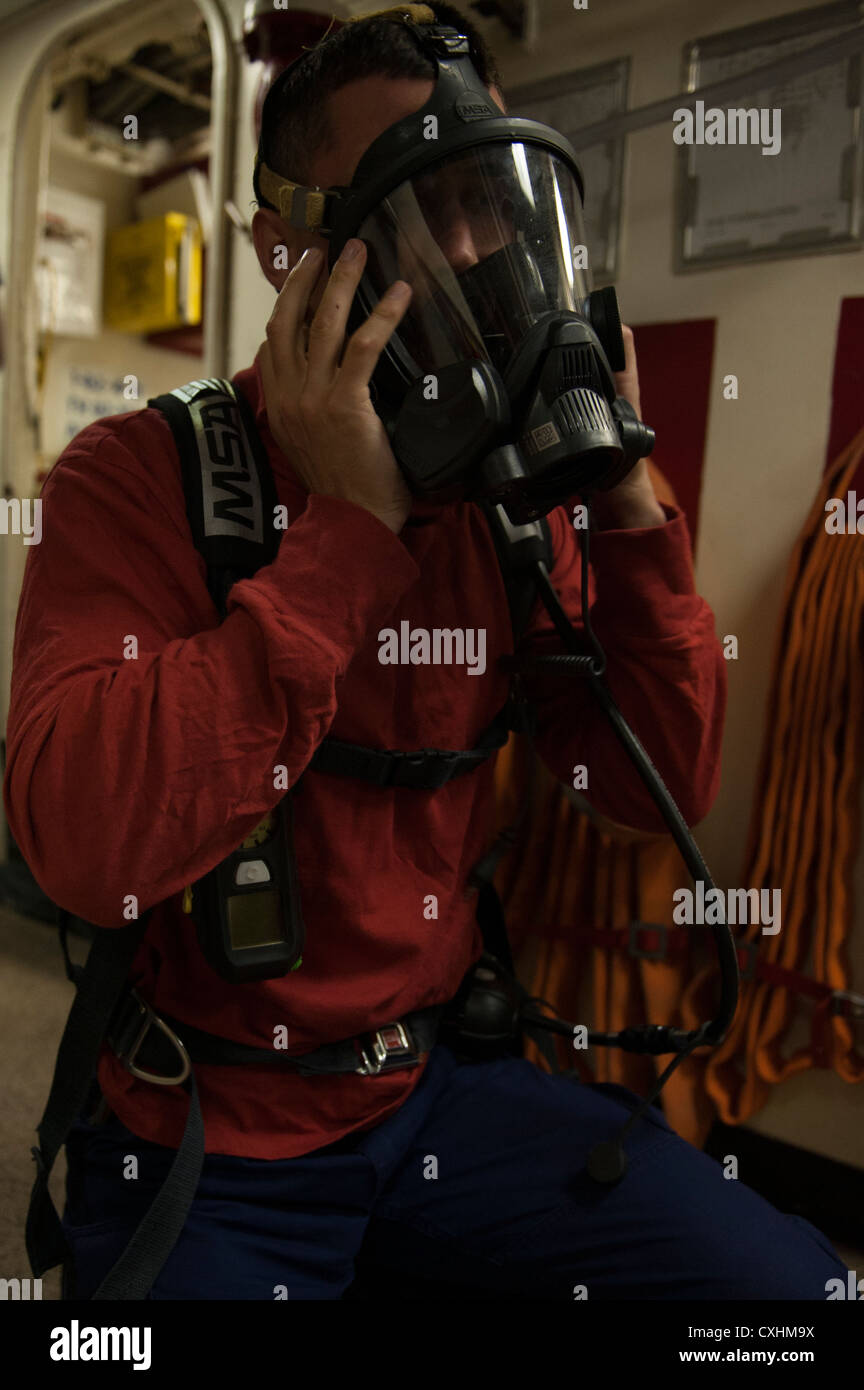 Petty Officer 1st Class Michael Davis prepares for damage control ...