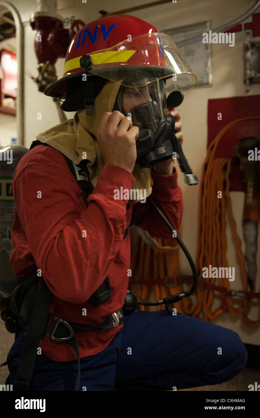 Petty Officer 1st Class Michael Davis participates in damage control ...