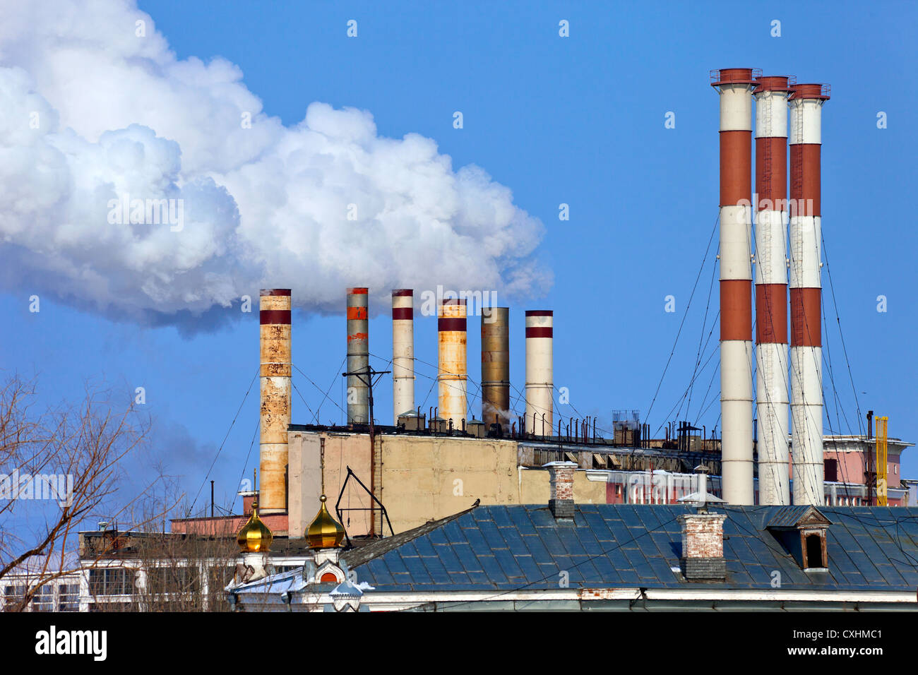 Lots of smoking chimneys other blue sky Stock Photo - Alamy