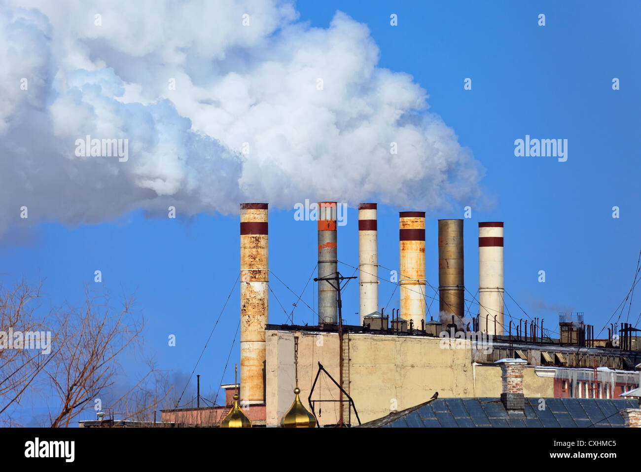 Lots of smoking chimneys other blue sky background Stock Photo - Alamy