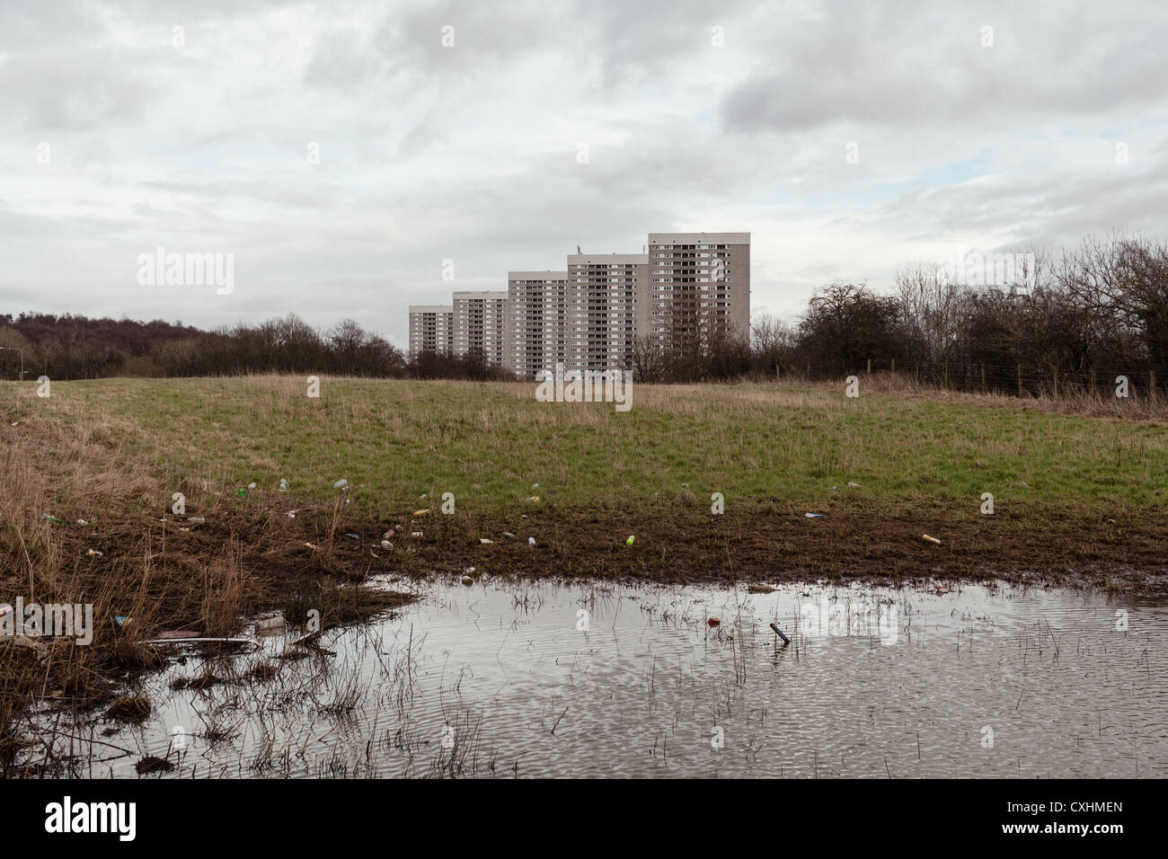 High rise flats with a wet muddy field in the foreground in Kennishead ...