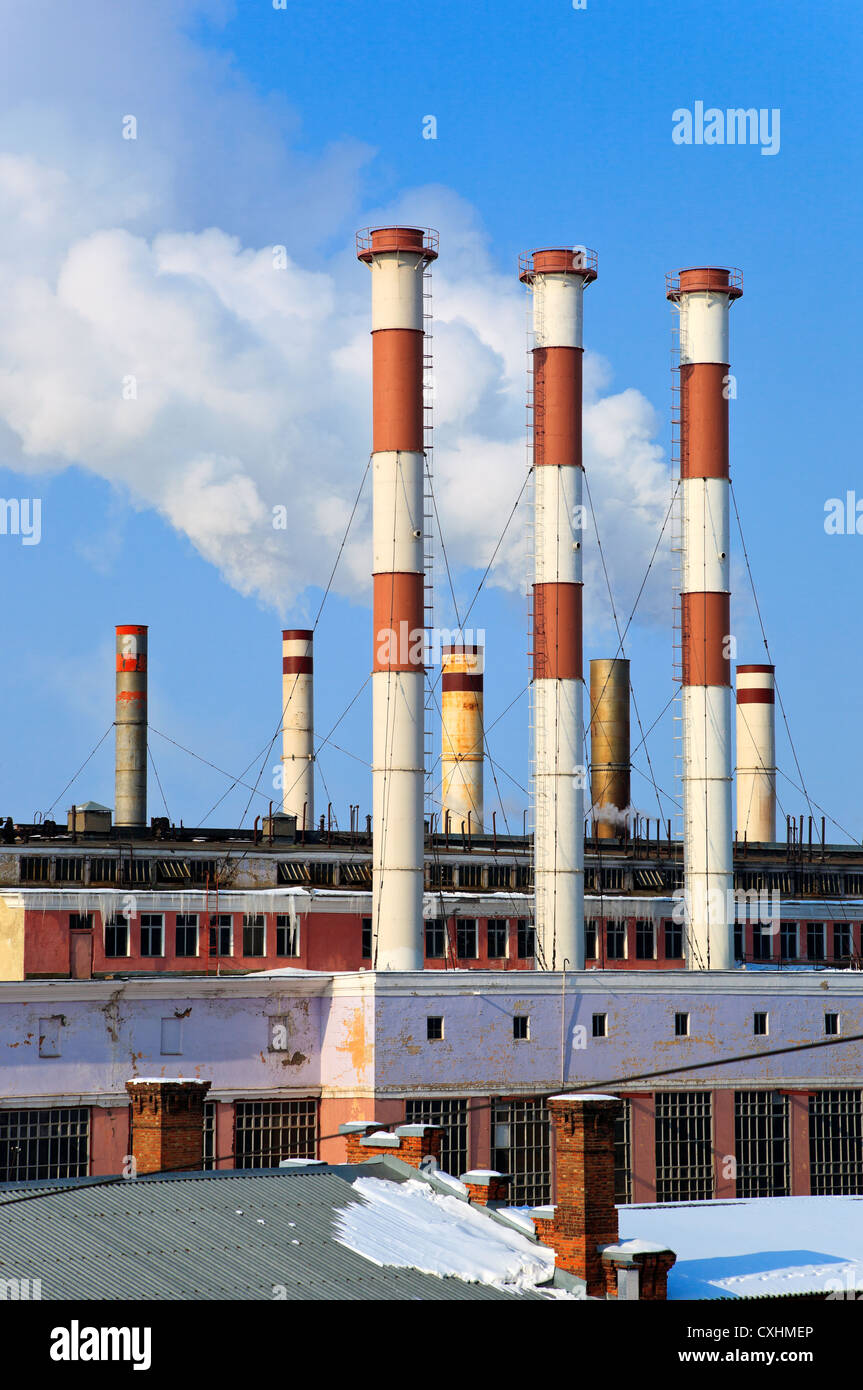 Lots of smoking chimneys other blue sky Stock Photo - Alamy