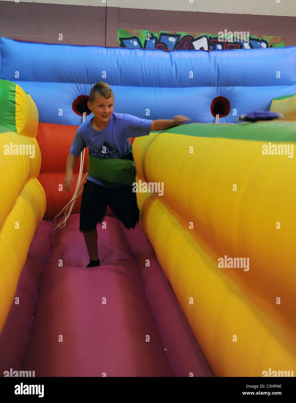A boy participates in an obstacle course at RAF Mildenhall Youth Center ...
