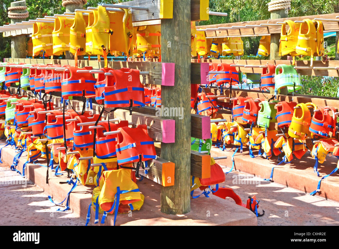 Two rows of colorful hanging life jackets Stock Photo - Alamy