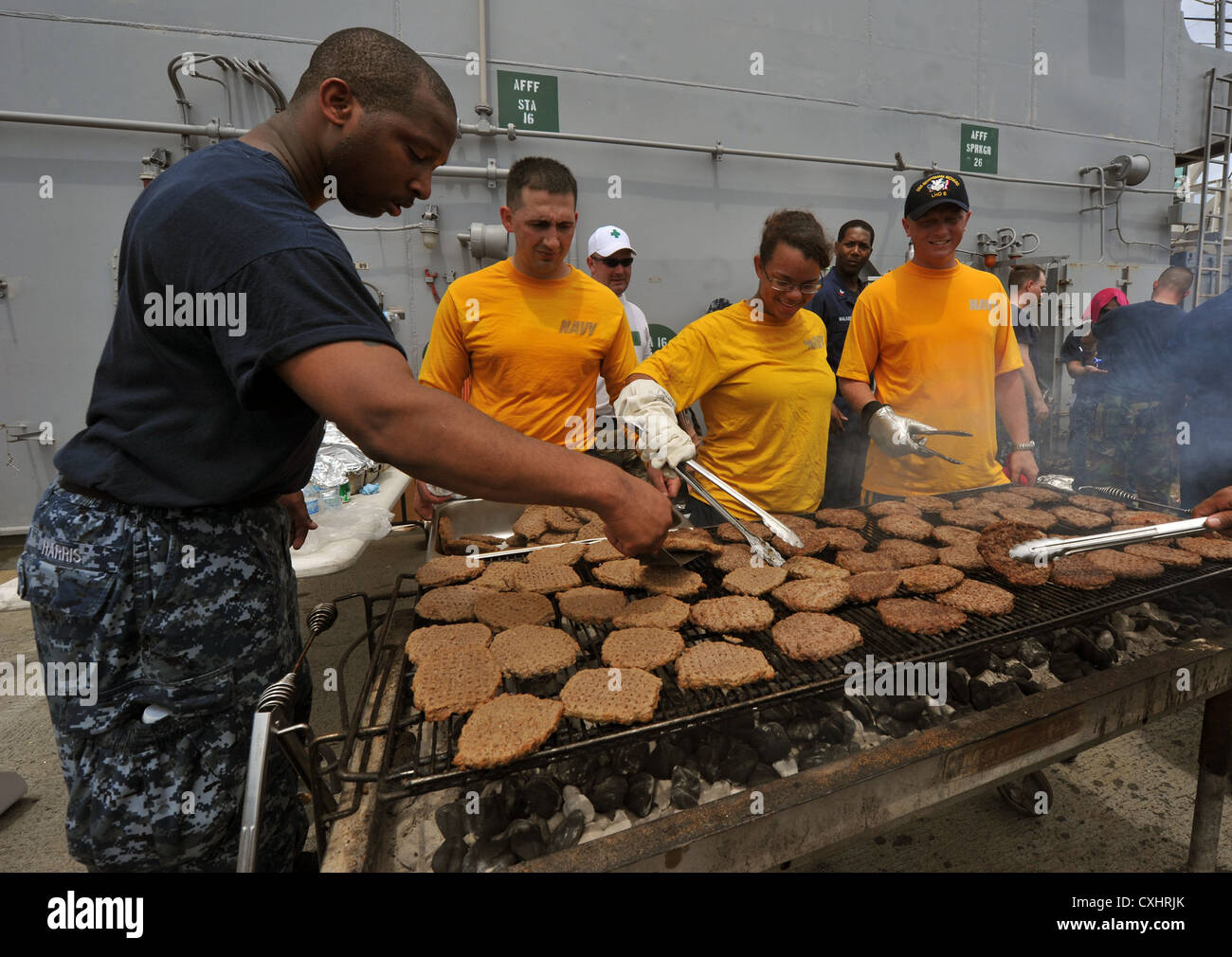 Sailors and Marines enjoy a steel beach picnic aboard the forward ...