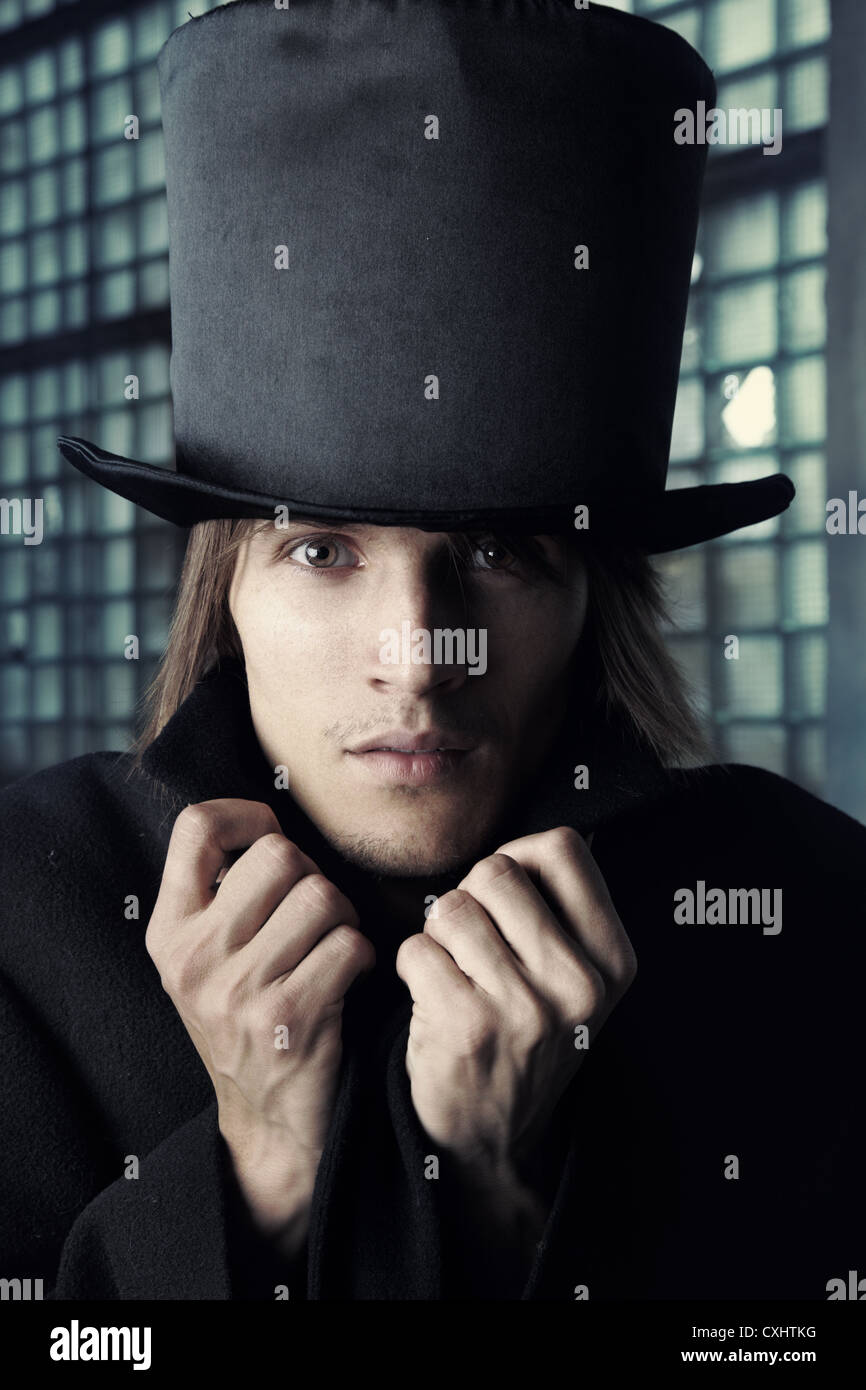 Retro portrait of the man in black top hat indoors Stock Photo - Alamy