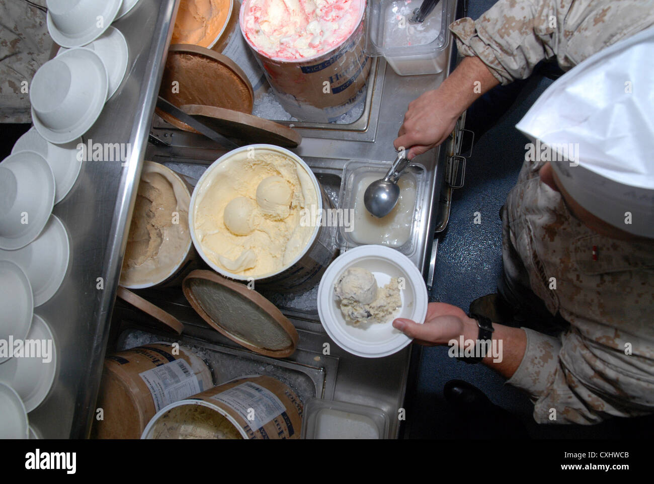 Marine Chief Warrant Officer Ricardo Rivera serves ice cream to the ...