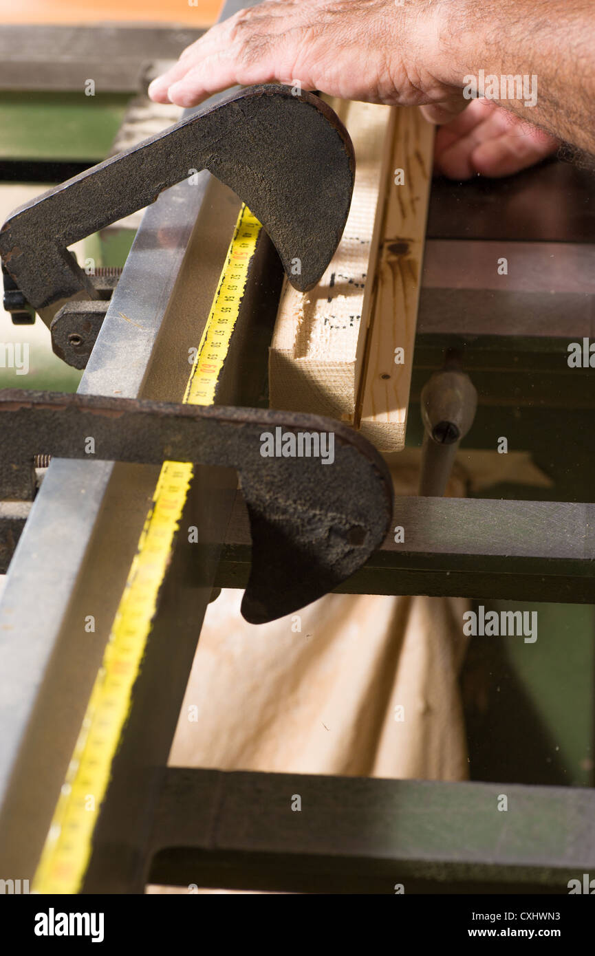 Hands of a carpenter measuring wood planks Stock Photo - Alamy