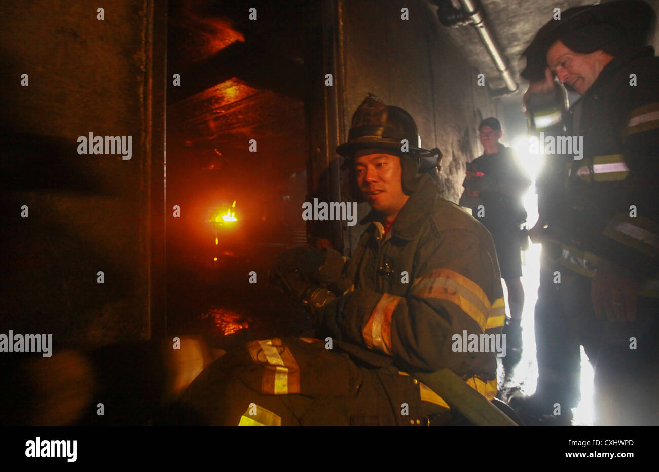 Marine veteran Peter Park prepares to extinguish a controlled fire ...