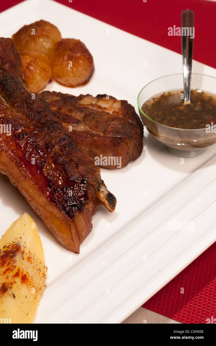 Grilled caramelized pork ribs served with garnish and Argentinian ...