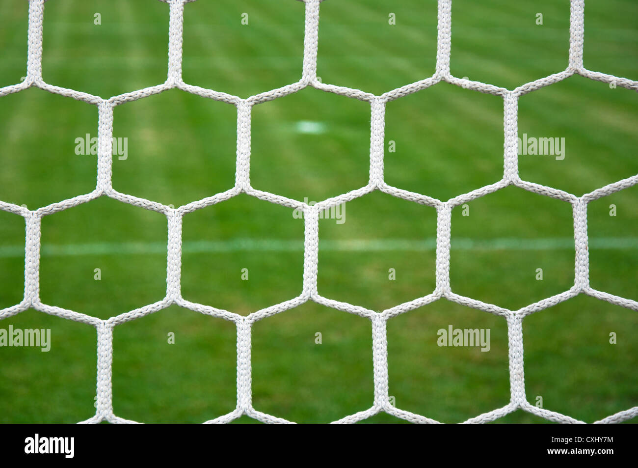 Close up detail of a soccer net against green grass Stock Photo - Alamy