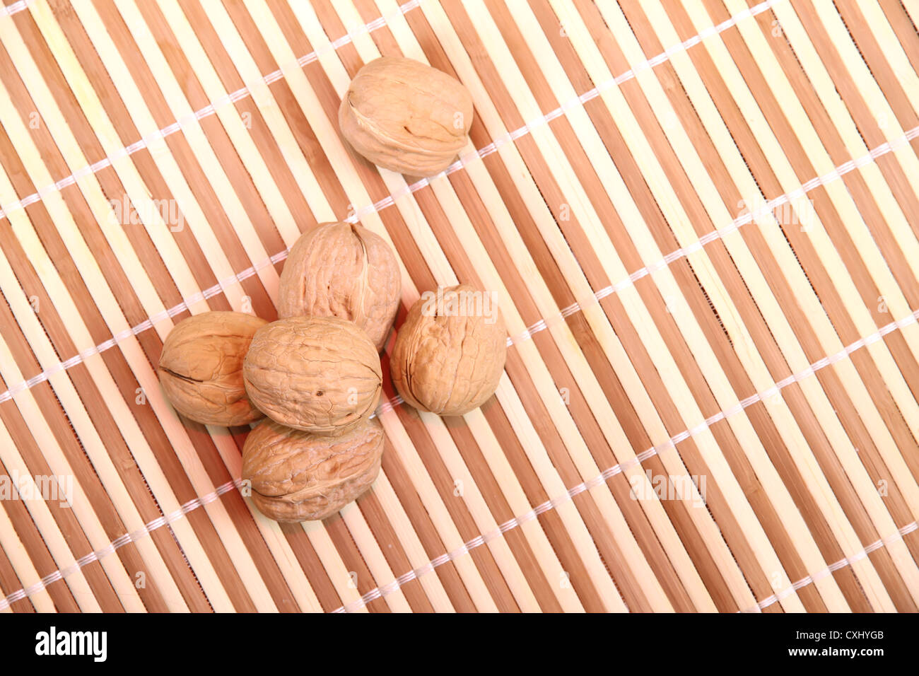 Some walnuts on a bamboo background Stock Photo - Alamy