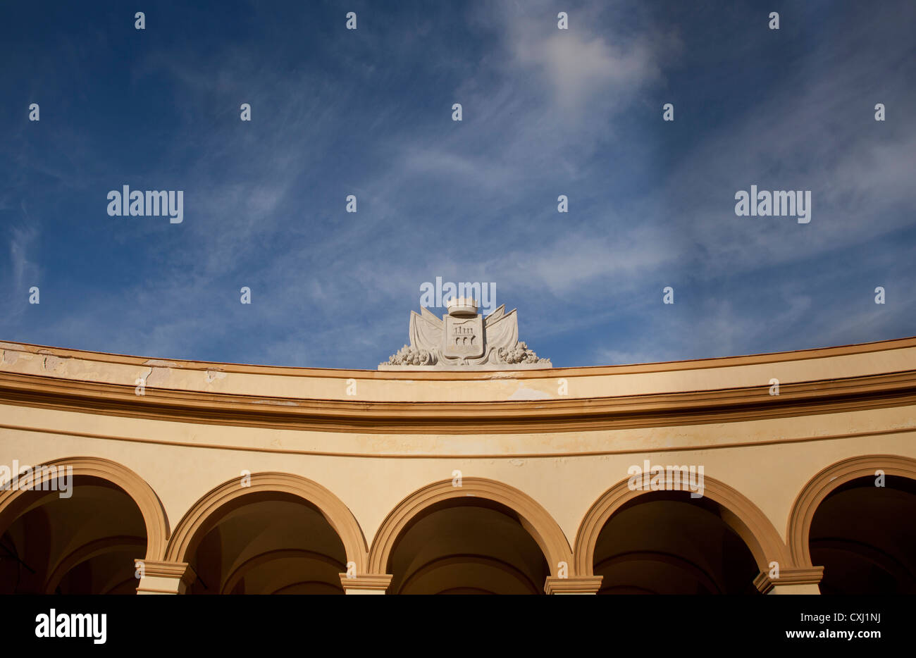 yellow arched building with blue sky, Trapani Stock Photo - Alamy