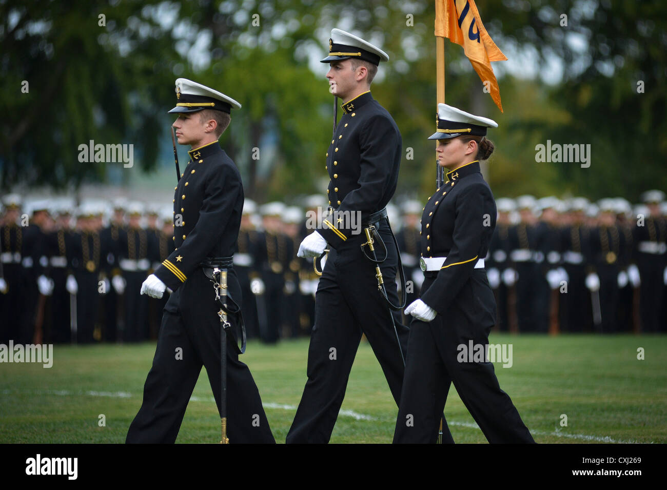 U.S. Naval Academy midshipmen participate in a pass in review parade ...