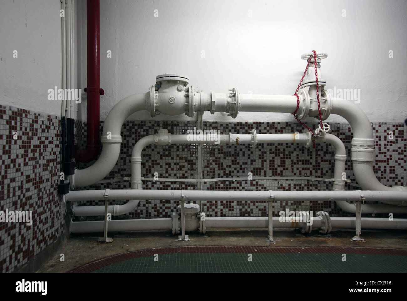 It's a photo of white steel pipes for water evacuation in a building in ...