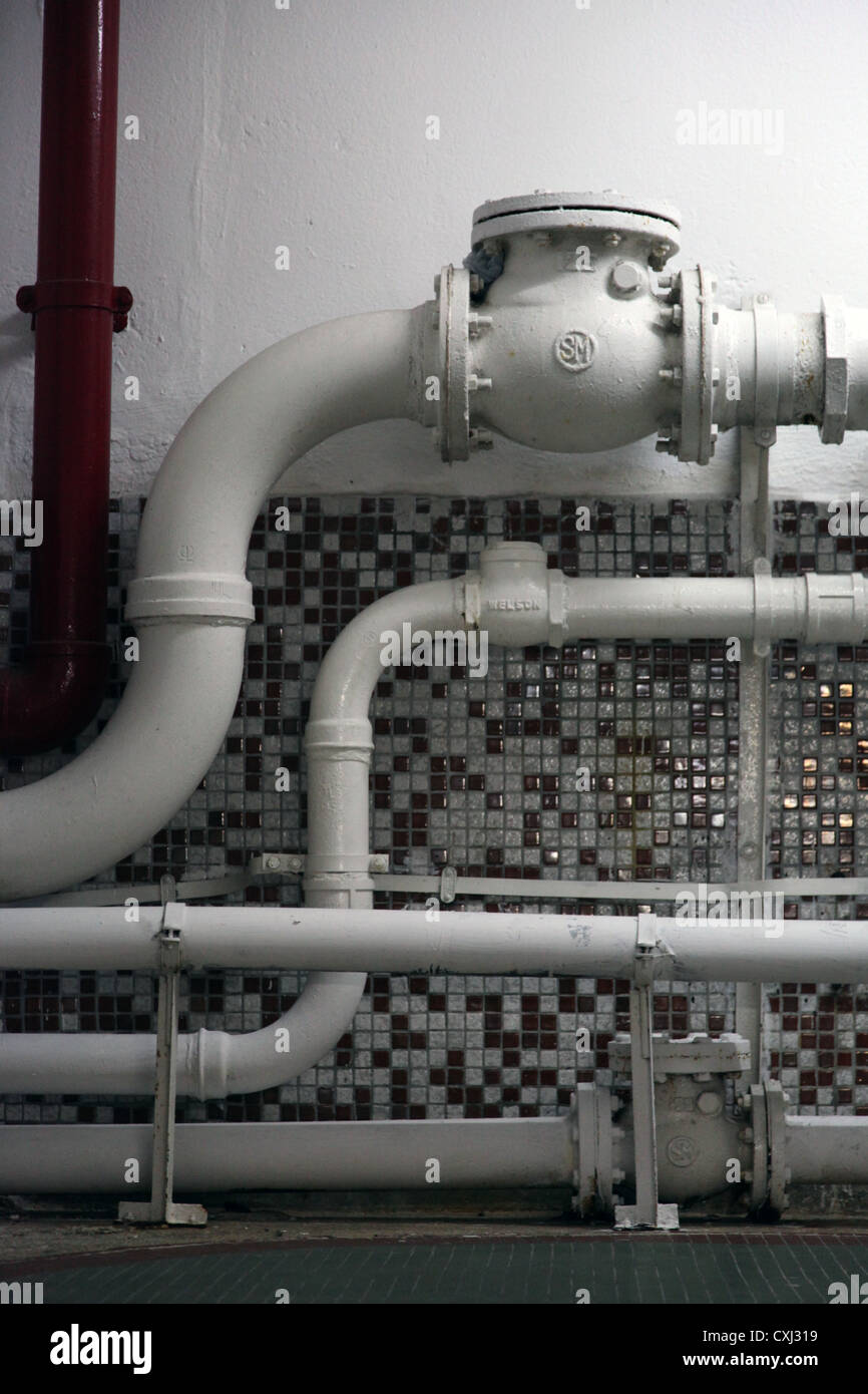 It's a photo of white steel pipes for water evacuation in a building in ...