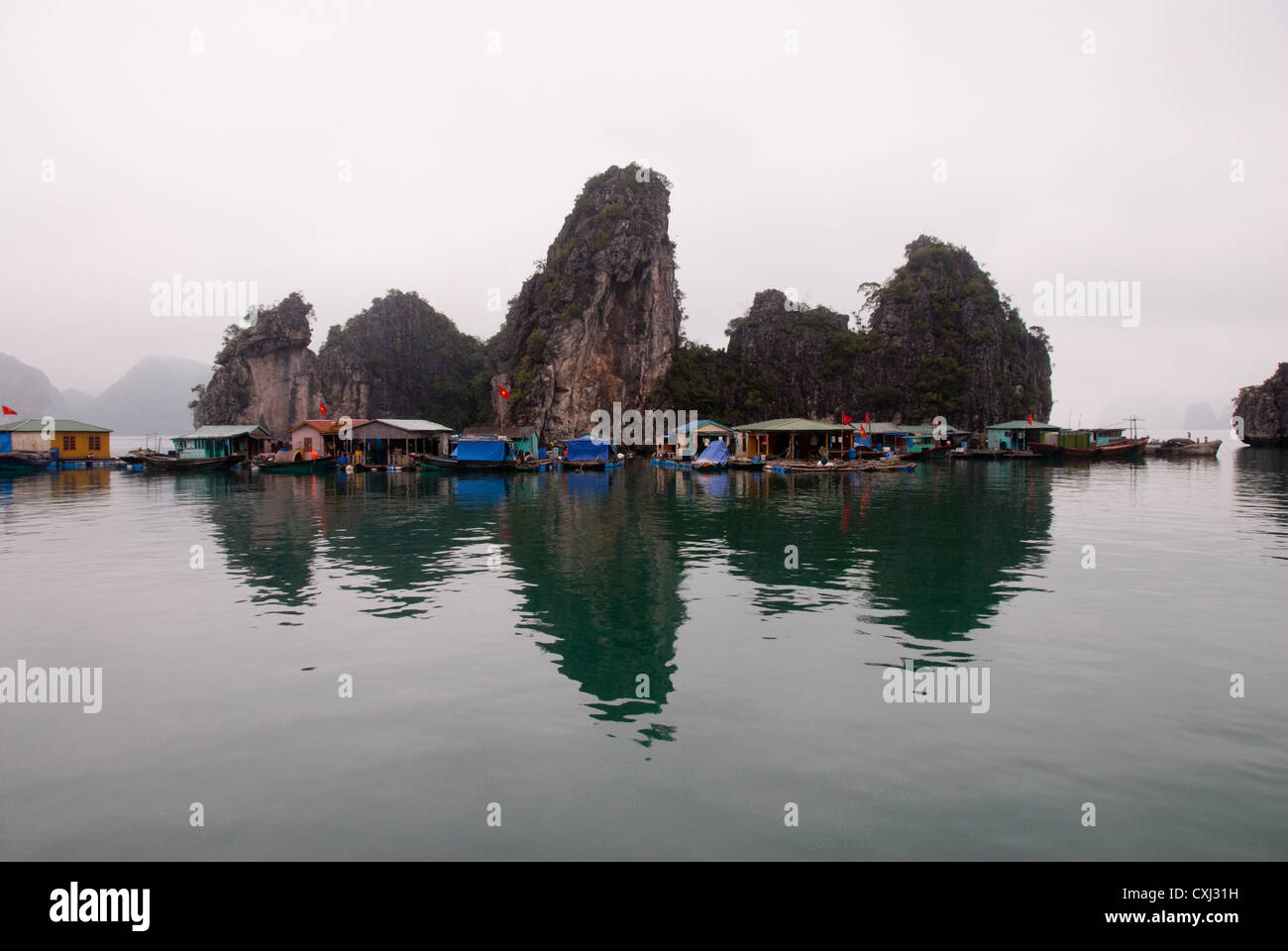Floating village and Limestone Karst rock formations, Halong Bay ...