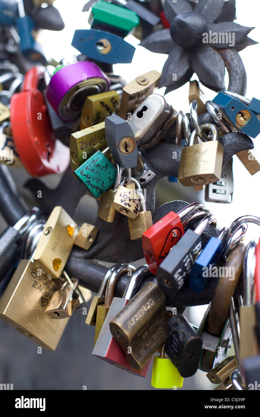 Love padlocks affixed to a fence gate or bridge by sweethearts to ...