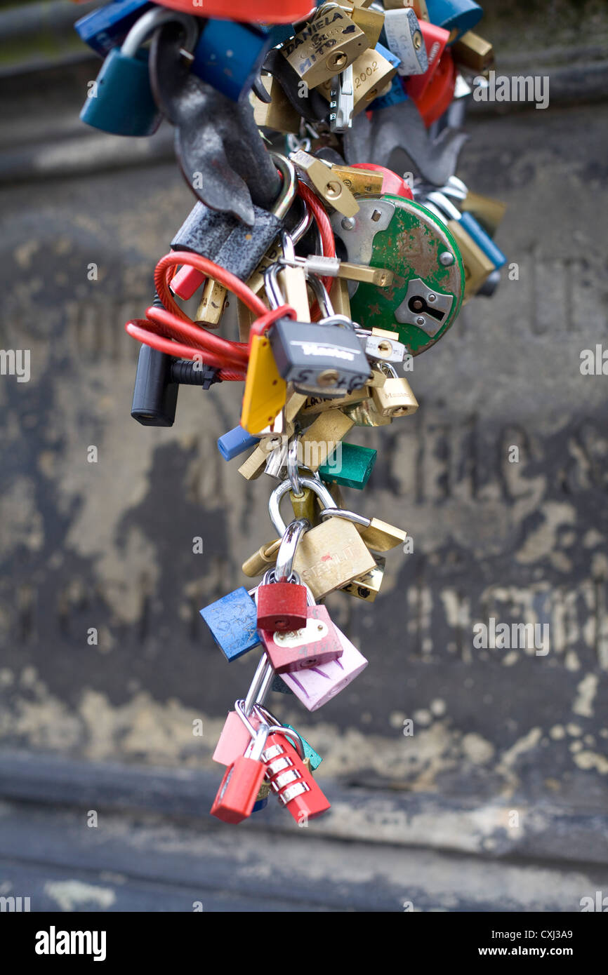 Love padlocks affixed to a fence gate or bridge by sweethearts to ...