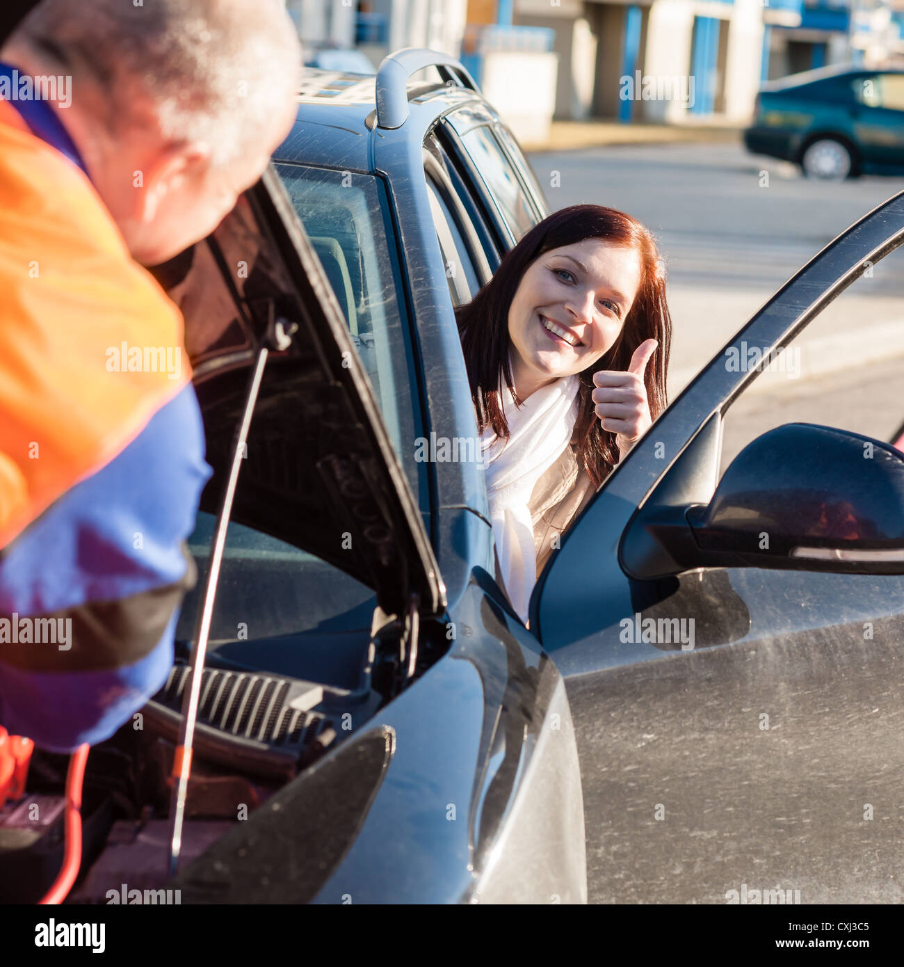 Mechanic fixing car happy woman thumb up breakdown problem Stock Photo ...