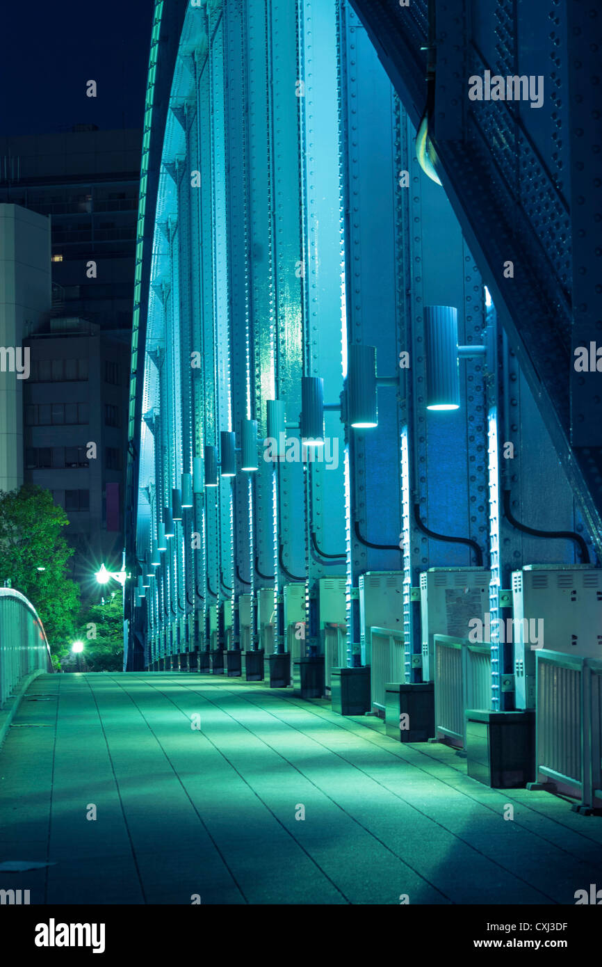 pedestrian way along the metallic arc structure of city bridge ...