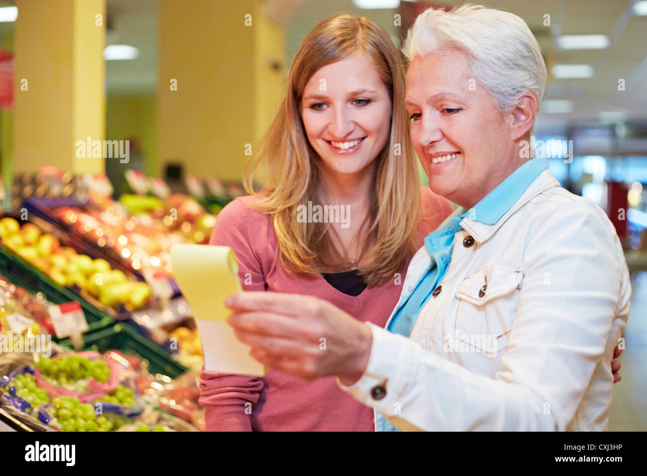 Germany, Cologne, Women with list in supermarket Stock Photo - Alamy