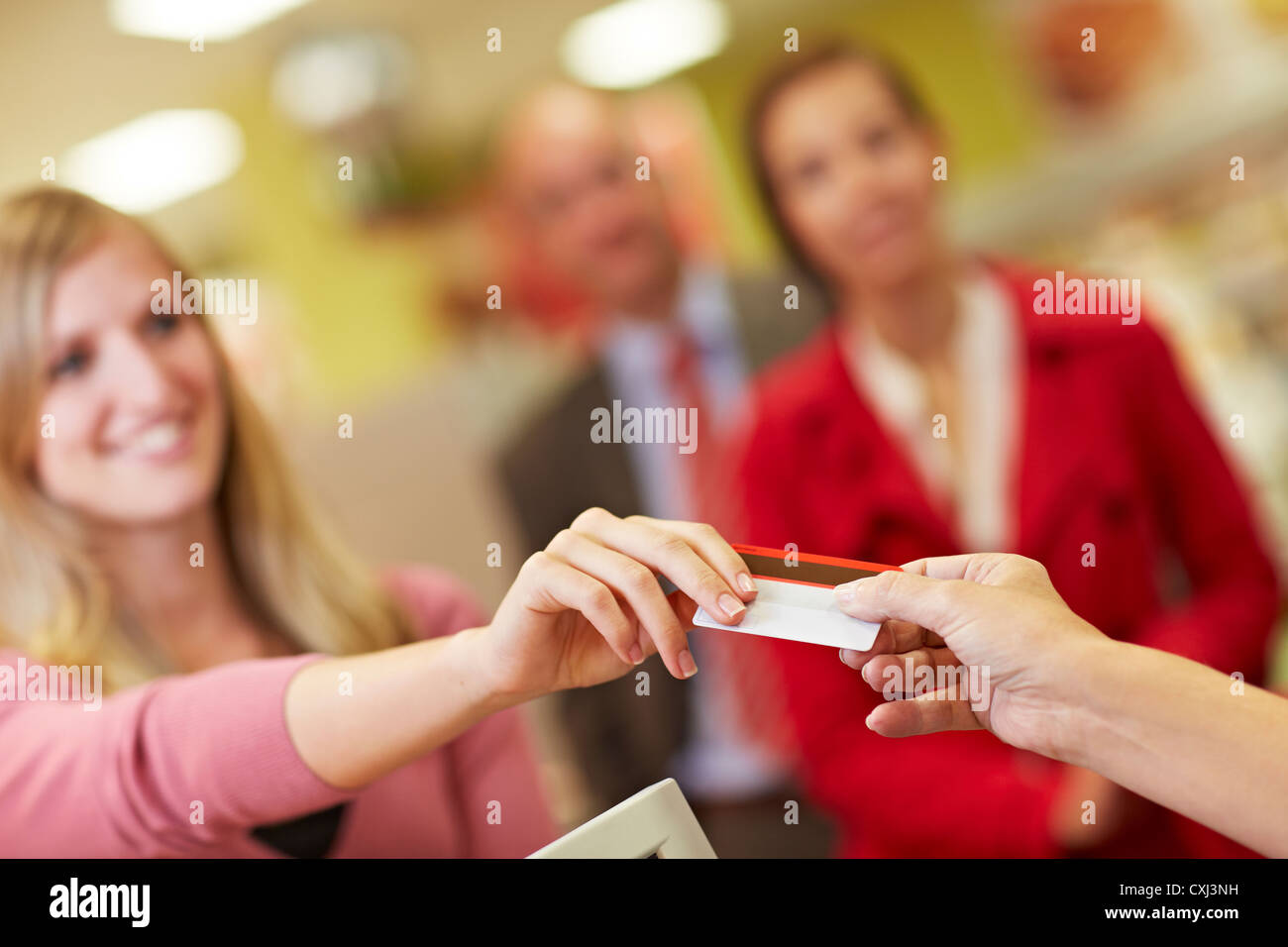 Germany, Cologne, People using credit card in supermarket Stock Photo ...