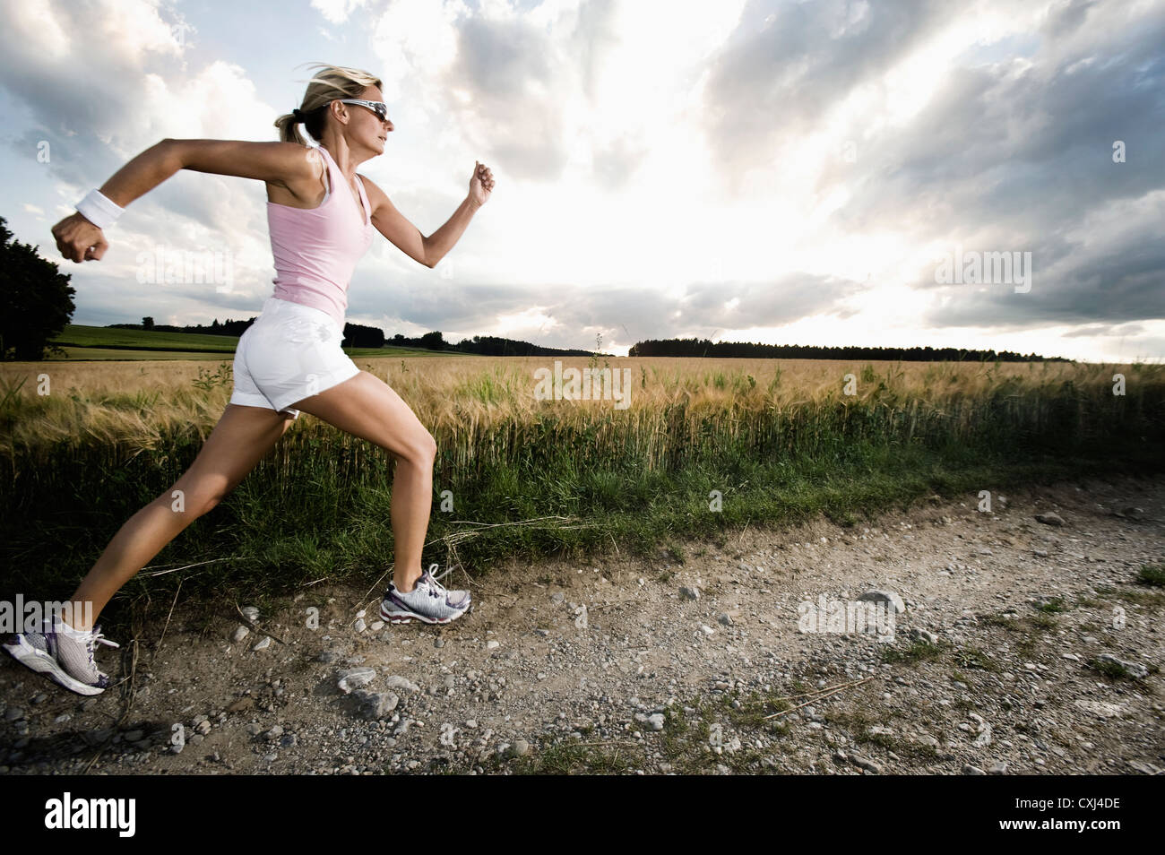 Germany, Bavaria, Mature woman running in grain field Stock Photo - Alamy
