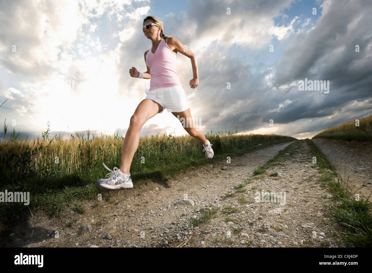 Germany, Bavaria, Mature woman running in grain field Stock Photo - Alamy