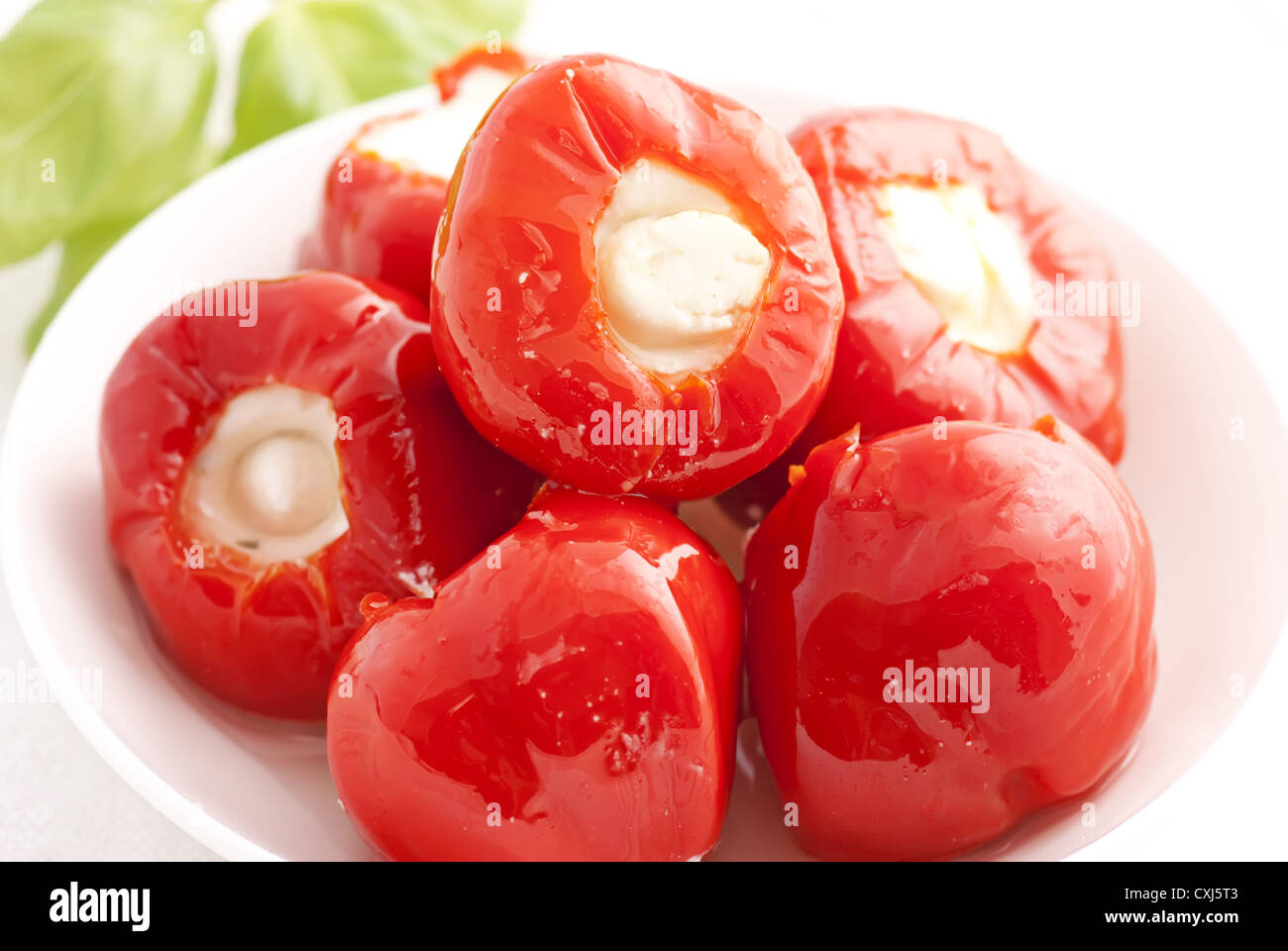 Pickled Paprika with Feta as closeup on a white plate Stock Photo - Alamy
