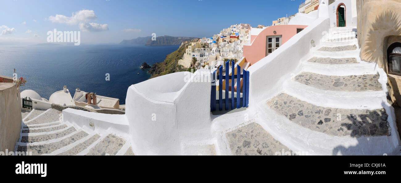 Greece, View of Oia village with cobbled path and blue gate at ...
