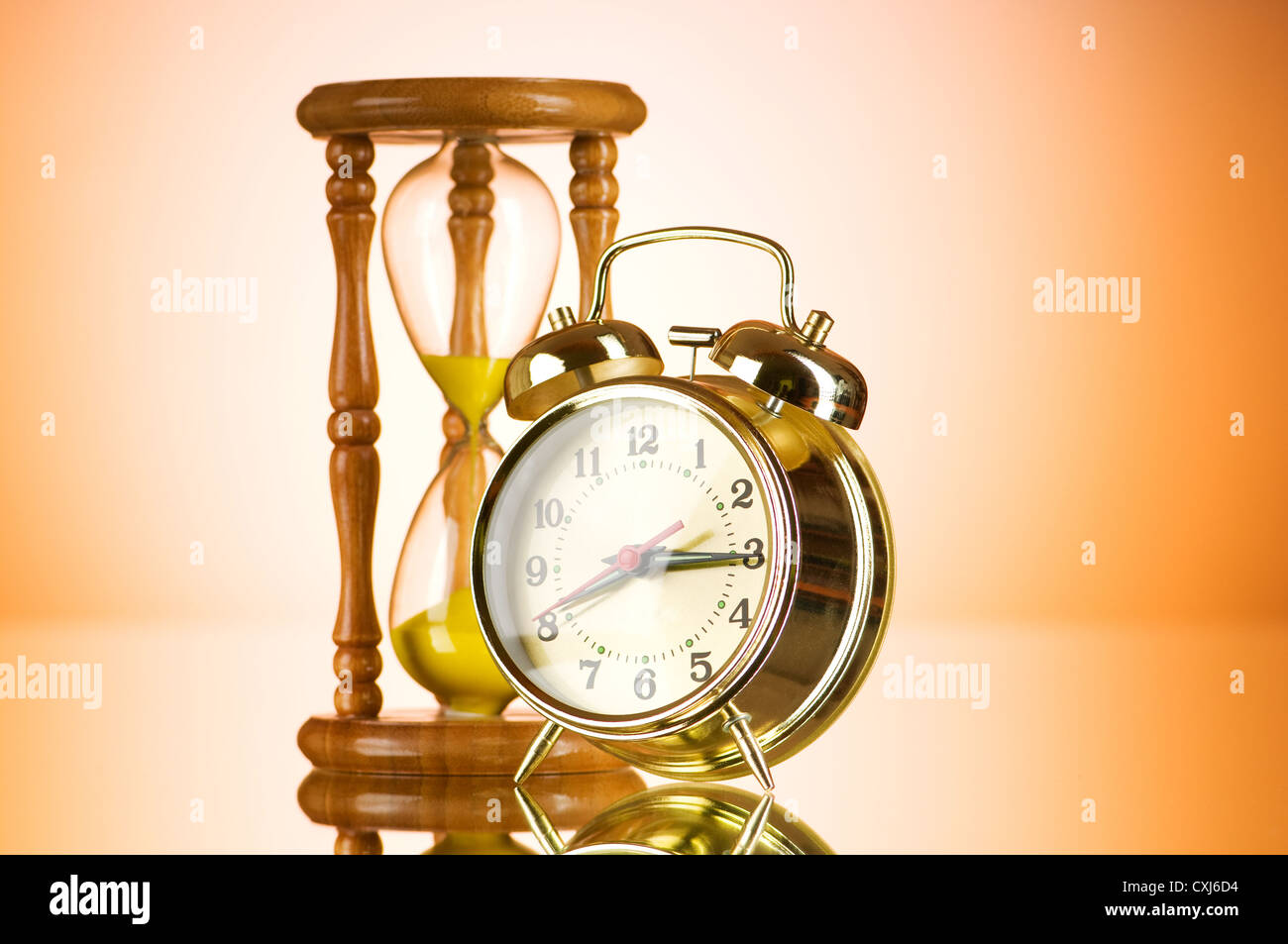Time concept with clock and hour glass Stock Photo - Alamy