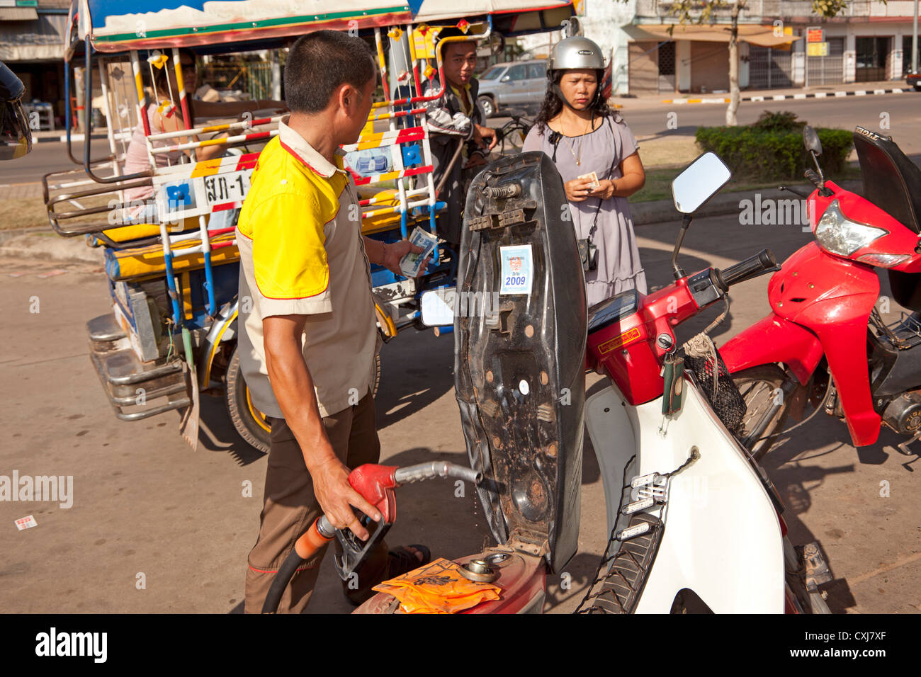 Filling motorcycle with petrol, Vientiane, Laos Stock Photo - Alamy