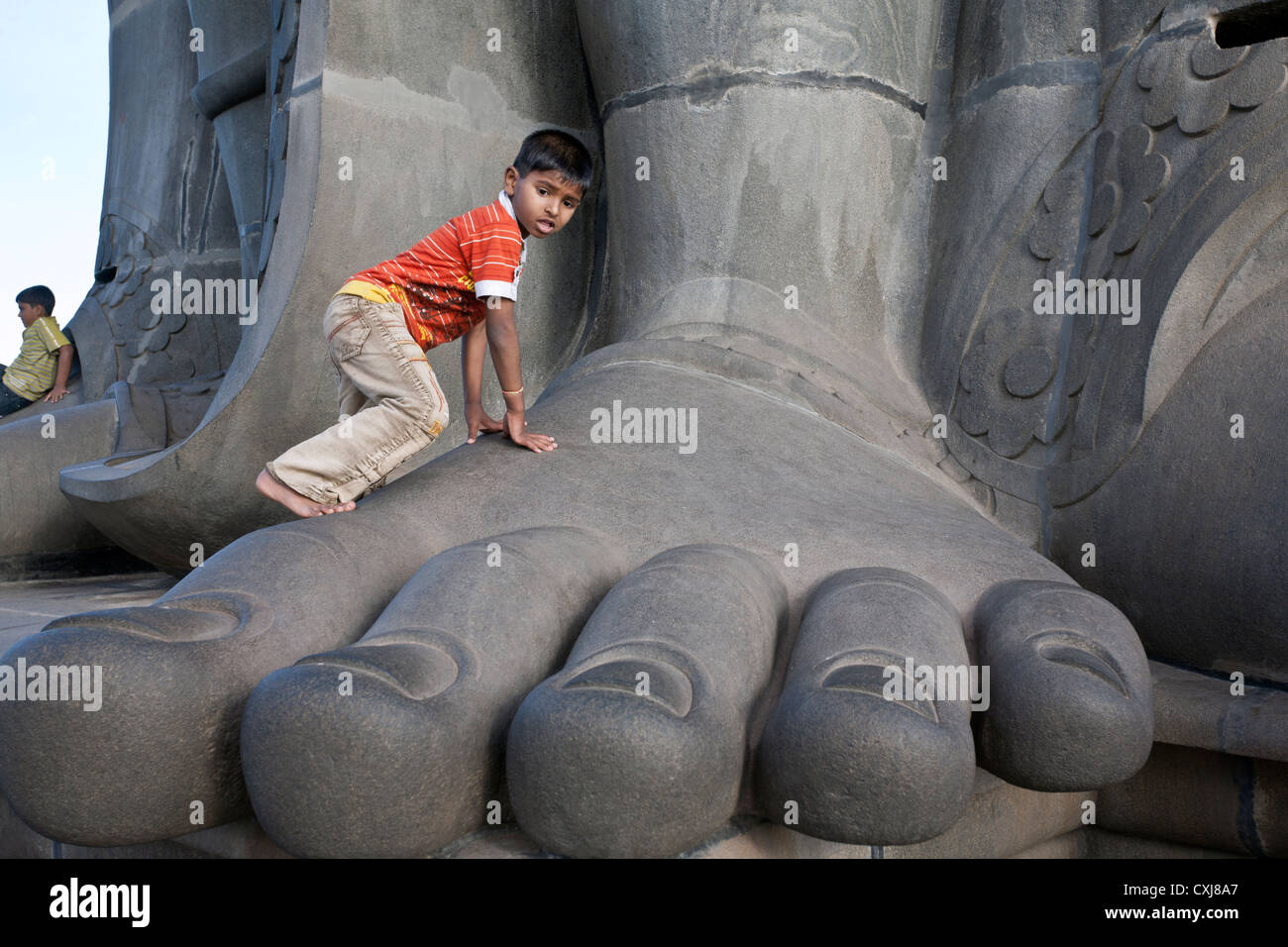 Boy walking on the giant foot of Thiruvalluvar statue (indian poet ...