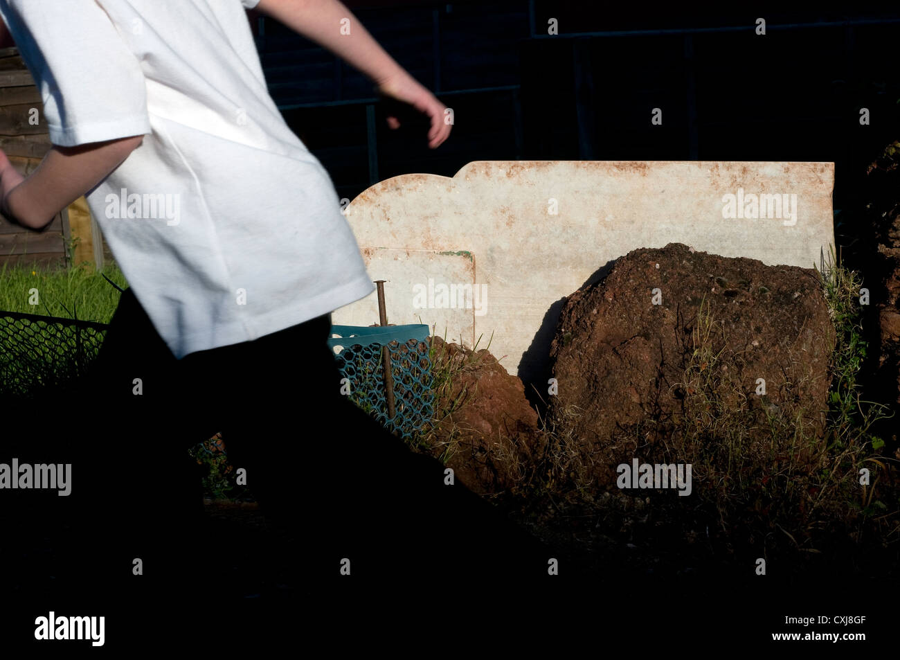 child running past gravestone,boy playing in graveyard Stock Photo - Alamy