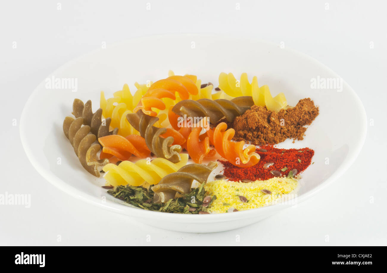 Colored pasta on the plate with blend of spices Stock Photo - Alamy