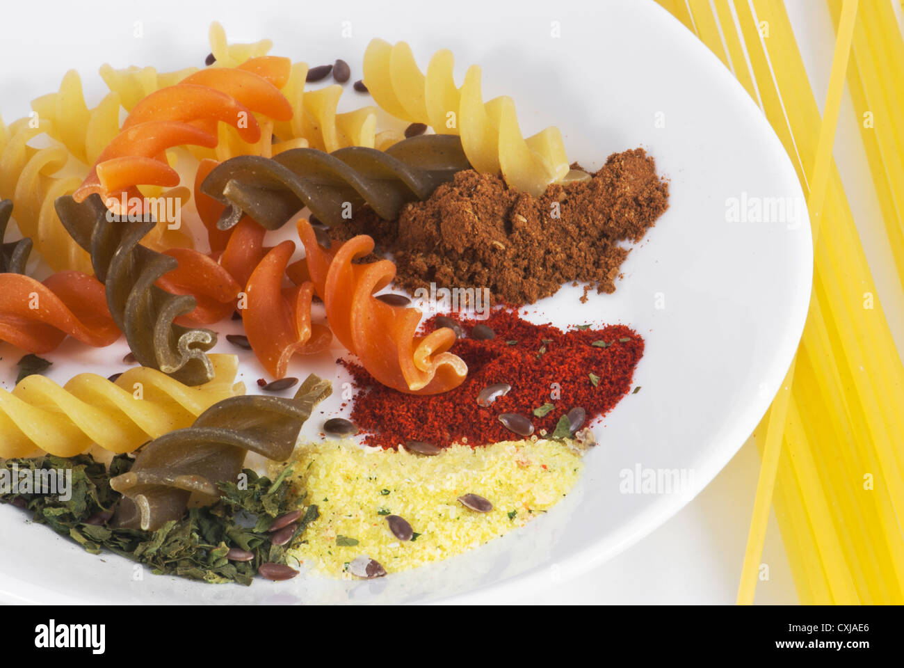 Colored pasta on the plate with blend of spices and spaghetti Stock ...