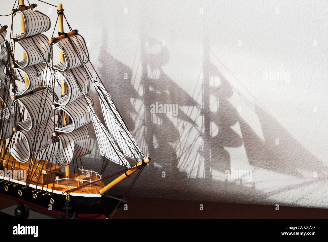 Model of the wooden ship with shadow on the wall Stock Photo - Alamy