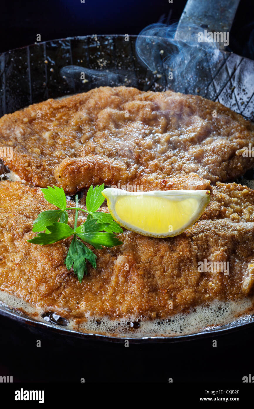 Wiener Schnitzel in frying pan Stock Photo - Alamy