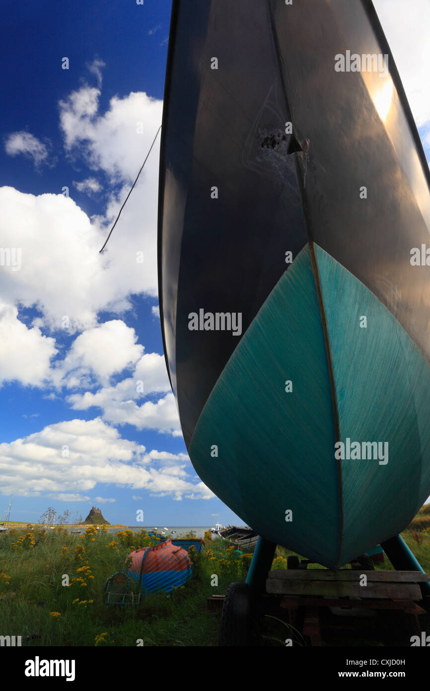 The underside of a boat's hull on Holy Island with the castle in the ...