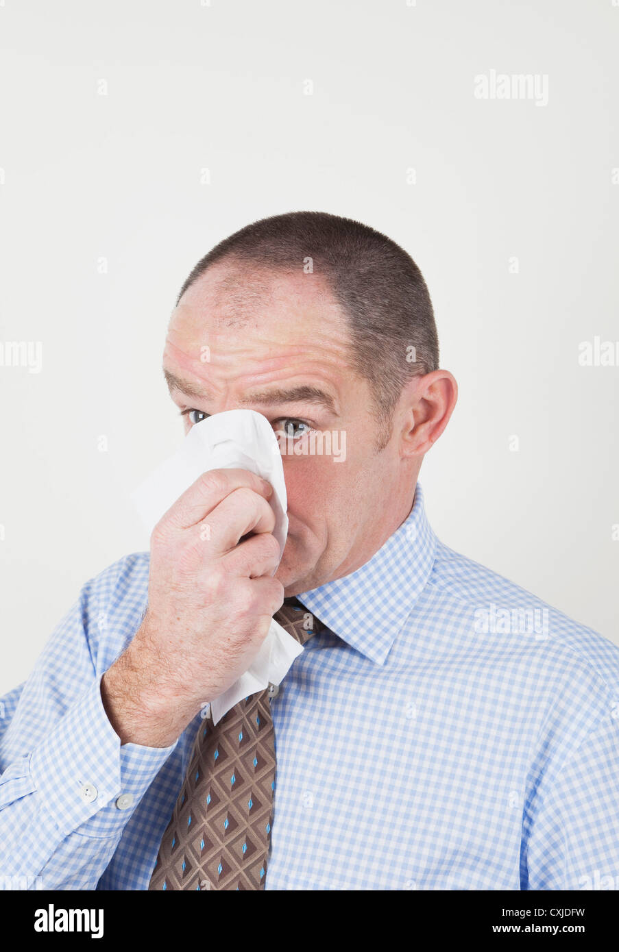 Businessman with blowing nose, close up Stock Photo - Alamy
